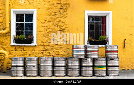 beer kegs outside window of old Irish pub Stock Photo - Alamy