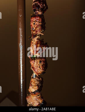 Traditional Madeiran beef skewer, known as espetada, served vertically ...