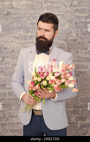 Flower for March 8. Bearded man with tulip flower bouquet. Love date ...