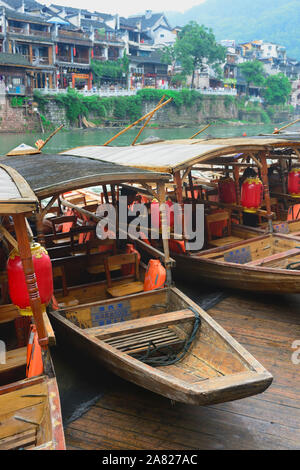 chinese gondola, wooden sampan boat with red lanterns parked at jetty ...
