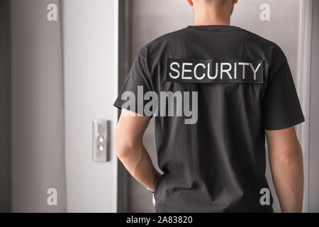 Male security guard near elevator Stock Photo - Alamy