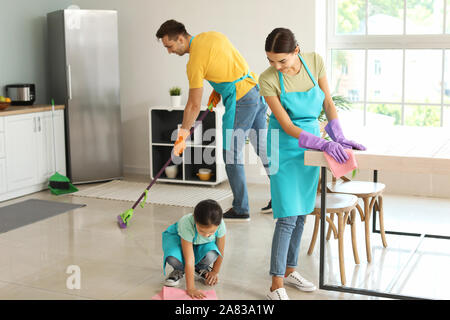 Happy family cleaning kitchen together Stock Photo - Alamy