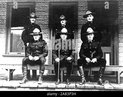 Six policemen posed on porch, Dawson, Yukon Territory, Canada, between ...