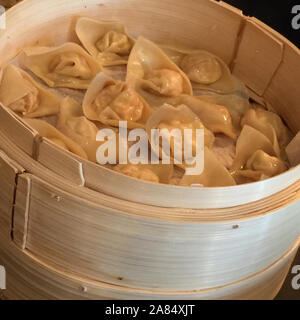 Vegan tofu and kimchi dim sum steamed in bamboo steamer Stock Photo - Alamy