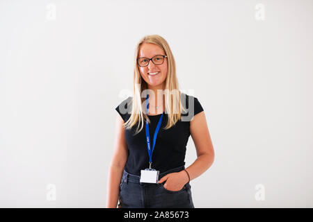 Young blonde woman smiling confident holding binder at waiting room ...