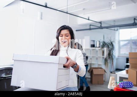 A young businesswoman moving in the office, getting new work place ...