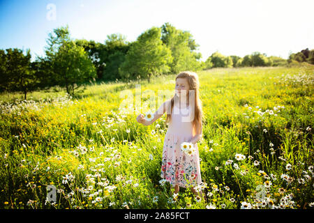 young girl skipping in field Stock Photo - Alamy