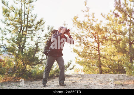 Male photographer with long wide lens camera work at nature, make shots ...