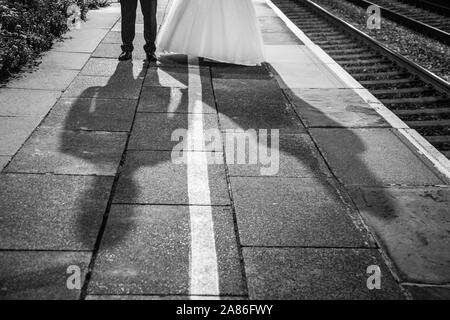 shadows after dark of a bride and groom on their wedding day, no faces ...