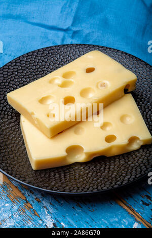 Two blocks of French emmental semi-hard cheese close up Stock Photo - Alamy