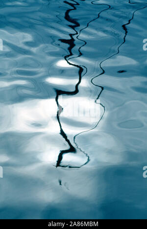 Abstract rippling water surface with swirling blue and white ...
