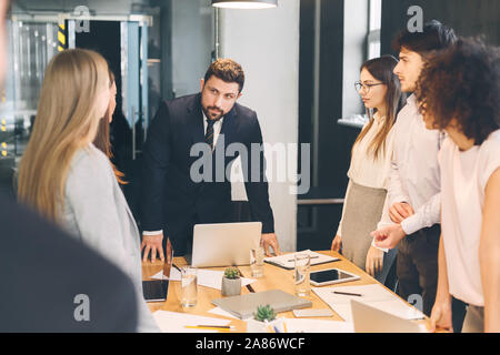 Female manager addressing workers in open plan office Stock Photo - Alamy