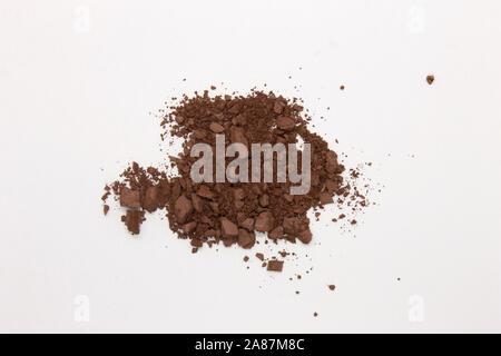 This is a photograph of a Dark Brown powder Eye shadow isolated on a ...