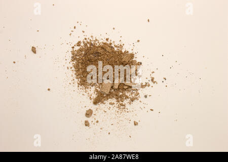 This is a photograph of pale Taupe powder Eye shadow isolated on a ...