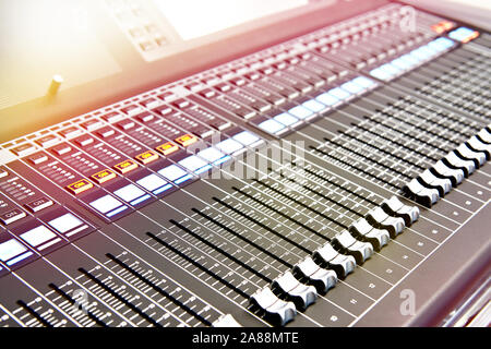 Electronic sound audio mixing desk console in recording studio showing ...