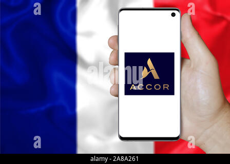 Logo of public company Accor displayed on a smartphone. Grey background ...