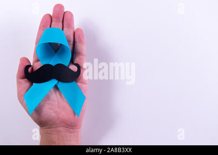 Man with light blue ribbon on color background with space for text ...