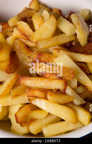 fried potatoes for cooking on an old kitchen table Stock Photo - Alamy