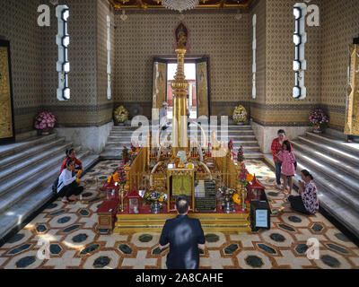 Worshippers at the phallic Lak Mueang (Lak Muang) or City Pillar in ...