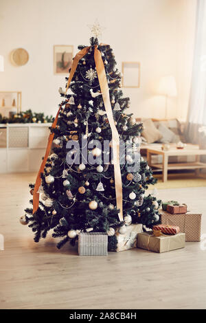 Beautiful gift boxes under Christmas tree in the room, close up Stock ...