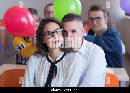 Campus life, students Love. Couple of students inside classroom ...