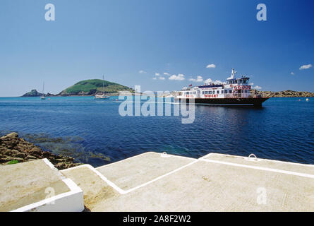 Tourist boats arrive at Herm Island located off the Guernsey coast ...