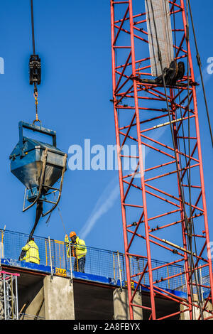 Workmen stand on the roof of a huge high rise Hilton Hotel development ...
