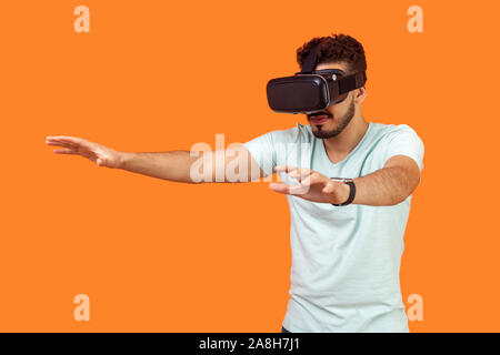 Hispanic man with beard wearing gamer hat and headphones pointing to ...
