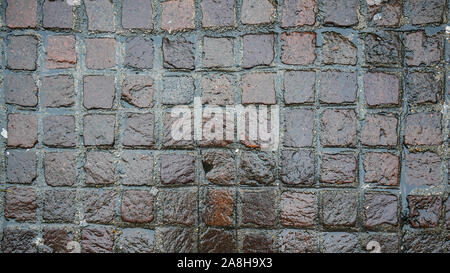 Wet square cobble stone road, texture photographed from above, London ...