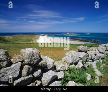 Countryside landscape with wall in the foreground and blue sky with ...