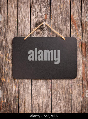 the simple sign board frame hanging on the wall of the building ...