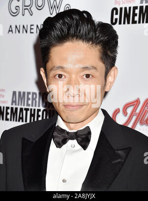 Kazu Hiro and Charlize Theron attending the Vanity Fair Oscar Party ...