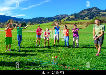 Teambuilding exercise called ball transport complex Stock Photo - Alamy