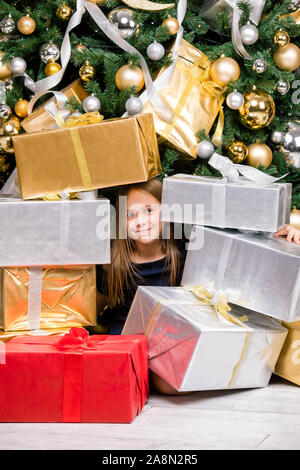 happy girl sitting near stack of books and globe while chatting on ...