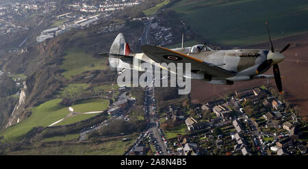 A World War II Spitfire, flies over the Battle of Britain Memorial in ...