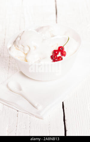Vanilla ice cream with red currant on white background Stock Photo - Alamy