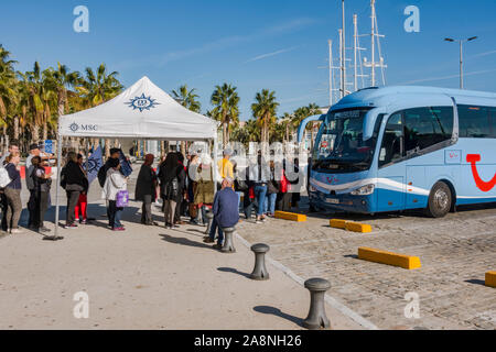 Vacationers lining up at a tour bus of TUI, shuttle bus bringing them ...