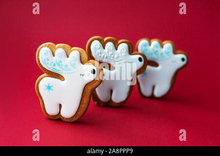 gingerbread cookie of little cute deer on red background. Traditional ...