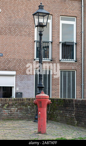 A Typical old Dutch red Hydrant standing in the City Stock Photo - Alamy