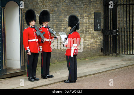 LONDON - MAY 6, 2012: A royal guard stands in traditional red jacket ...