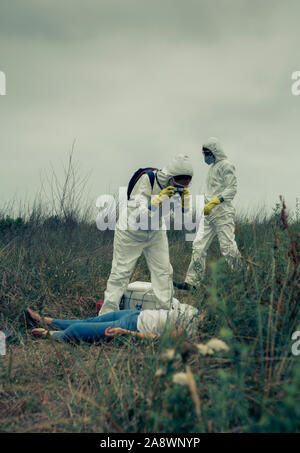 Multiracial man and woman in protective clothing working together at ...