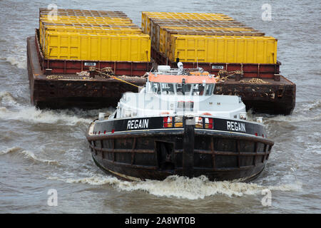 A barge being towed by tugboat Stock Photo - Alamy