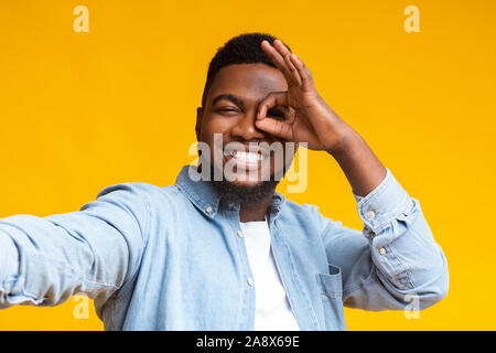 Photo portrait man gesturing like winner isolated vibrant yellow color ...