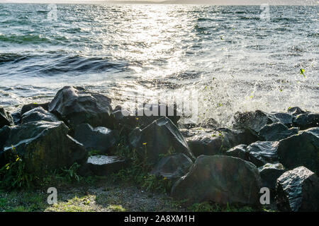 Wave from the Puget Sound hit rocks on the shoreline in Des Moines ...