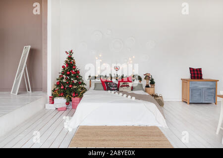 Beautiful Christmas decor and comfortable bed in bedroom. Interior ...