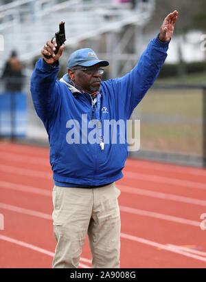 Race official firing a pistol at the start of a race Stock Photo - Alamy