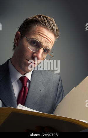 Skeptical businessman in his office Stock Photo - Alamy