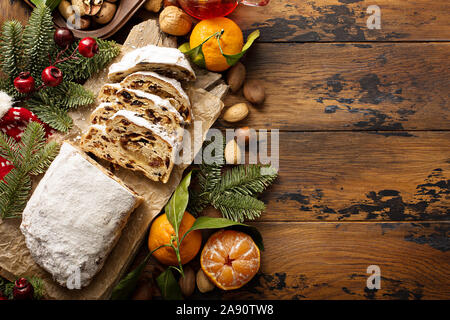 Traditional Christmass stollen with marzipan and dried fruit on rustic ...