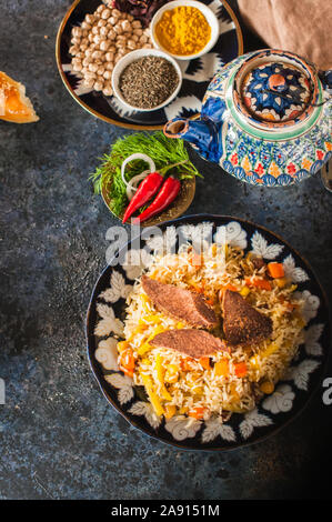 Pilaf on plate with oriental ornament and Traditional Asian breads ...