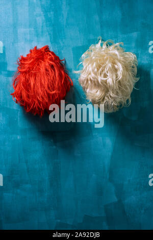 Two wigs hanging on a wall Stock Photo - Alamy
